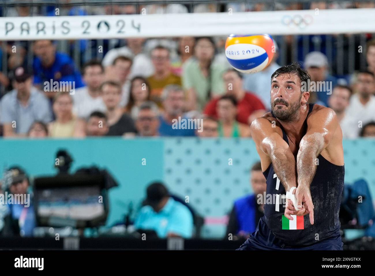 Italy's Alex Ranghieri returns a shot from Norway in a beach volleyball ...