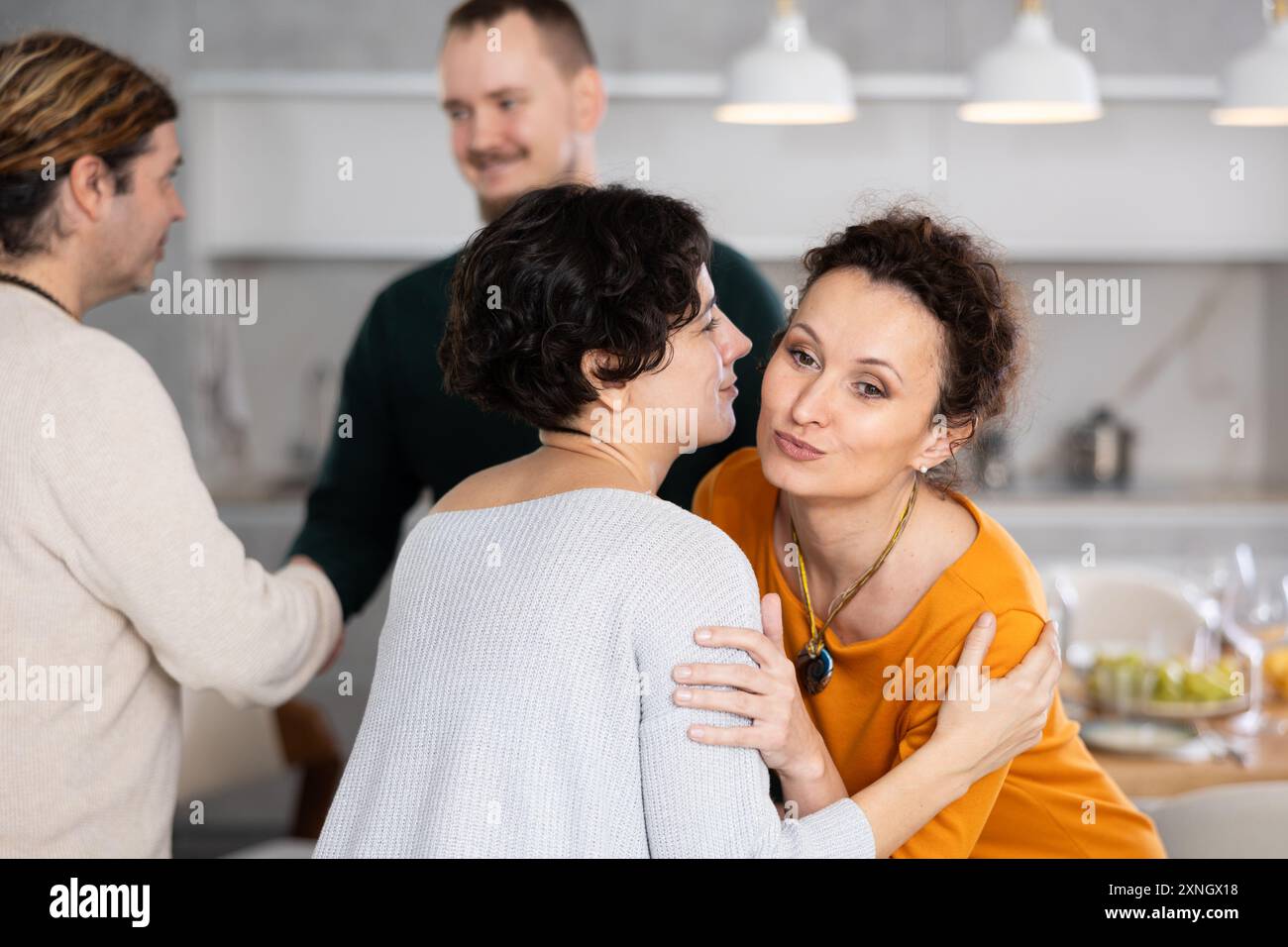 After chatting and gatherings, women friends hug and kiss goodbye Stock ...
