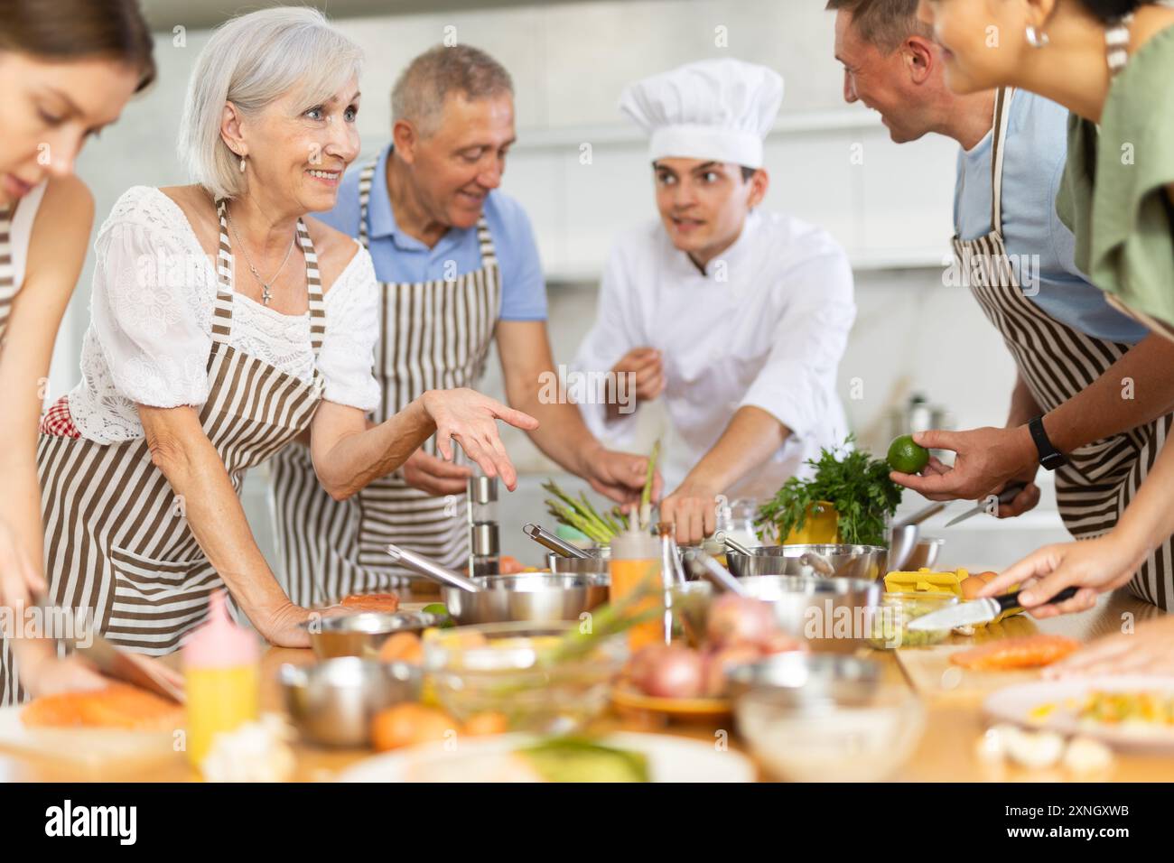 Young guy cook teaches to cook group of people Stock Photo - Alamy