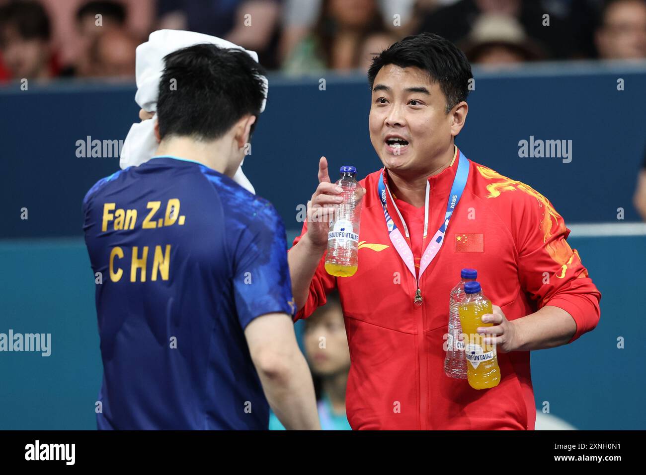 Paris, France. 31st July, 2024. Fan Zhendong (L) of China talks to coach Wang Hao during the men ...