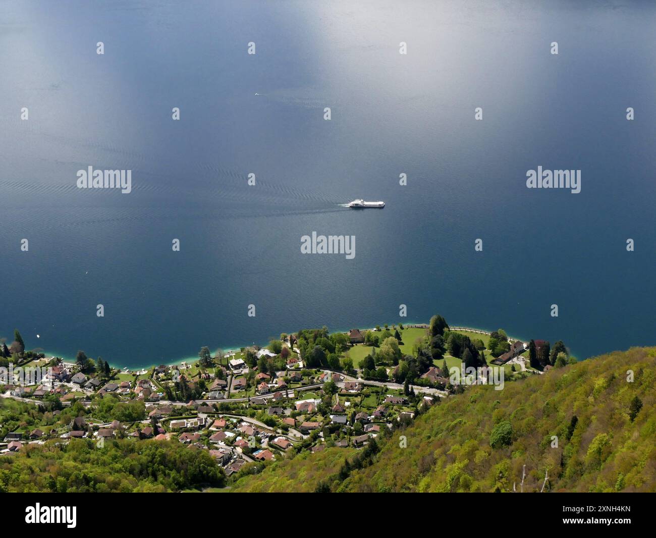 aerial view of annecy lake with isolated boat and Veyrier du Lac town ...