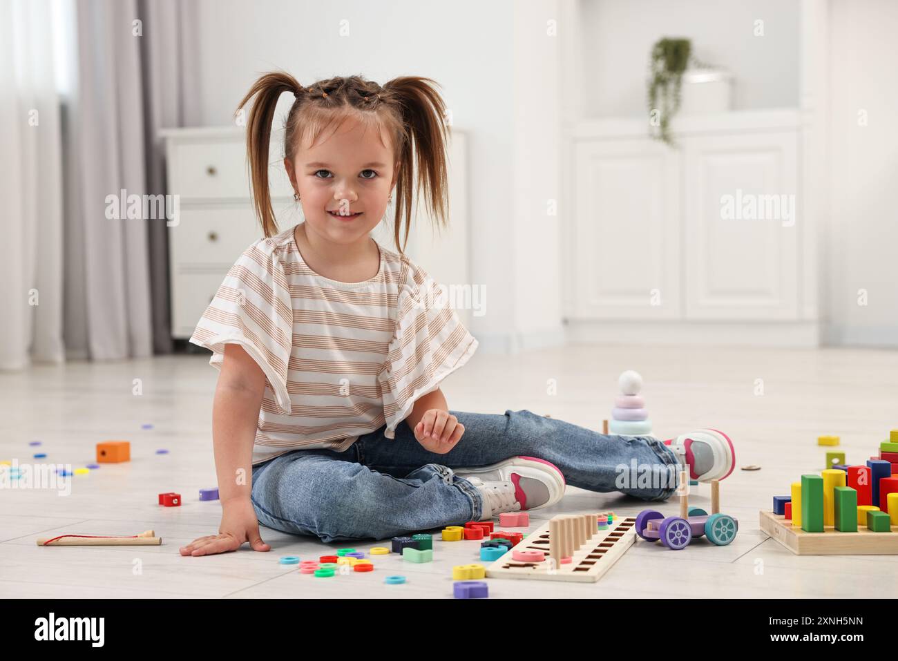 Cute little girl playing with math game Fishing for Numbers on floor ...