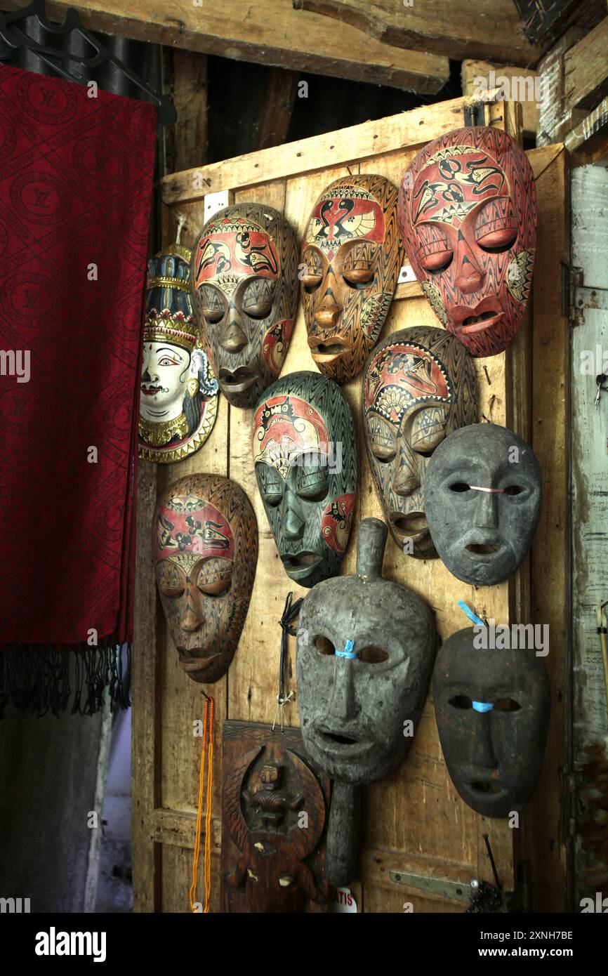 Ornamental carved masks at a souvenir shop in Lemo, North Toraja, South ...