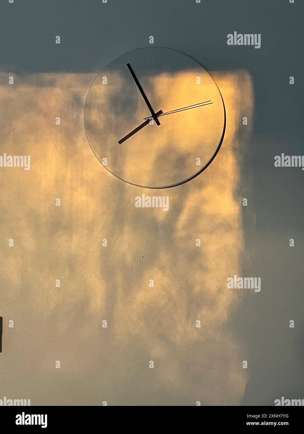 Minimalist wall clock with soft golden light casting shadows. Perfect ...