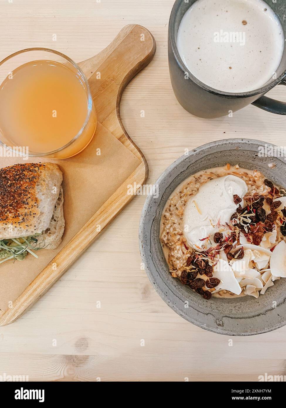 A healthy breakfast with oatmeal, a whole grain sandwich, coffee, and ...