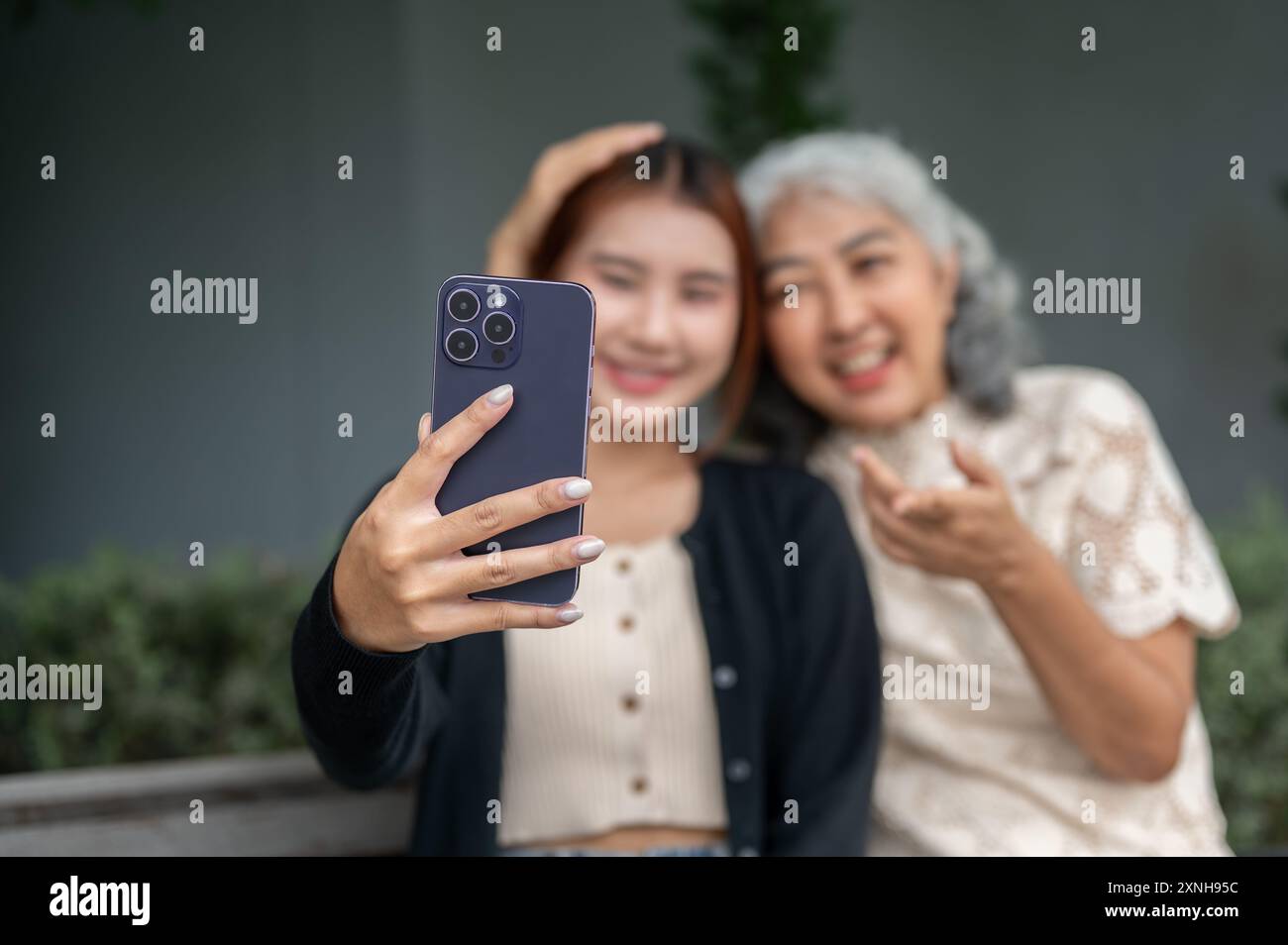 A selective focus image, a lovely Asian granddaughter and her grandma ...