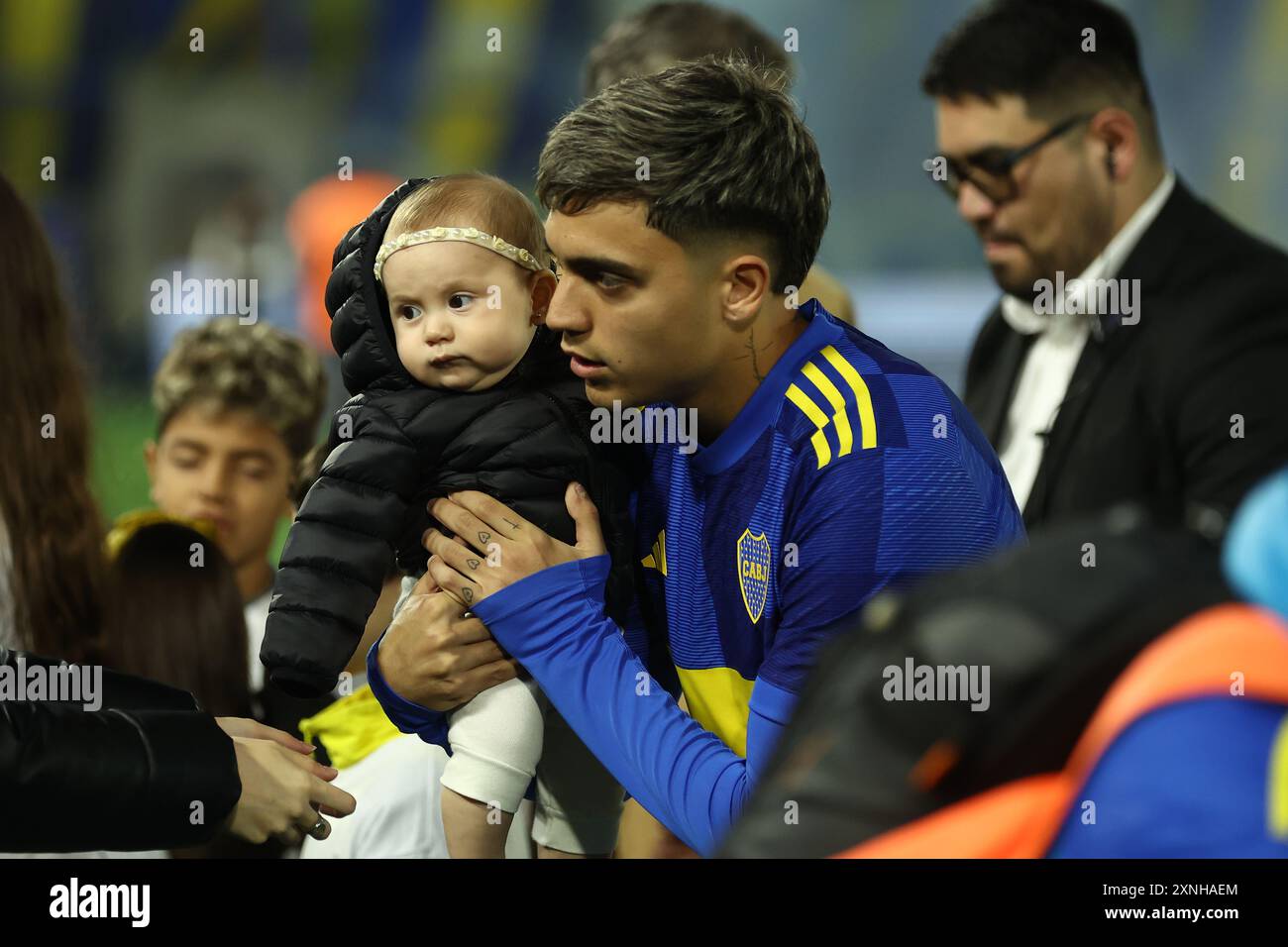 Boca Juniors' forward Ezequiel Zeballos (R) holds daughter before the ...