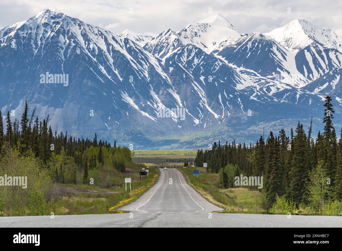 Alaska Highway driving into Haines Junction town in spring time with ...