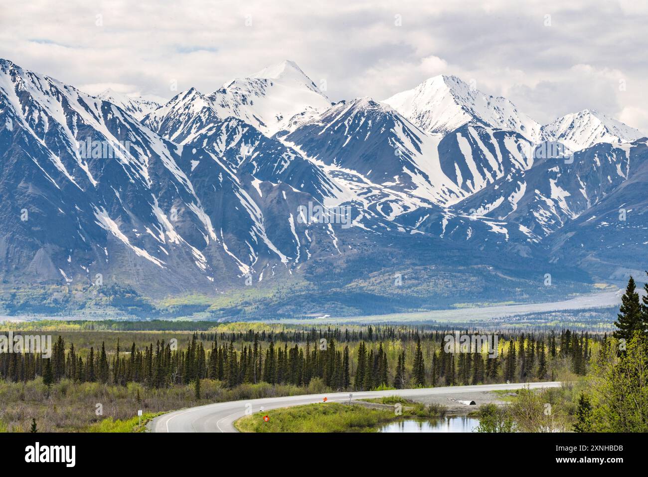 Alaska Highway driving into Haines Junction town in spring time with ...
