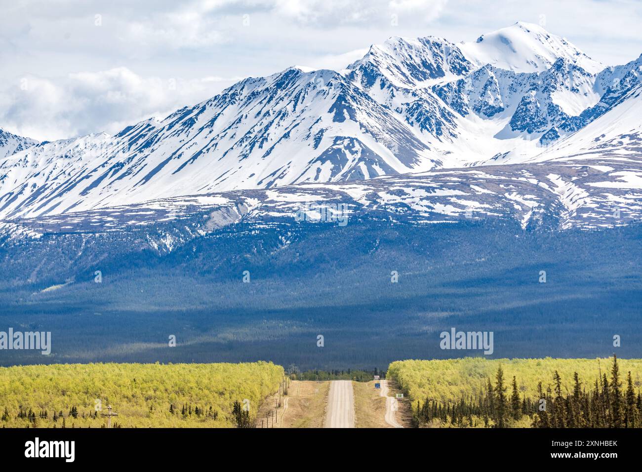 Alaska Highway driving into Haines Junction town in spring time with ...