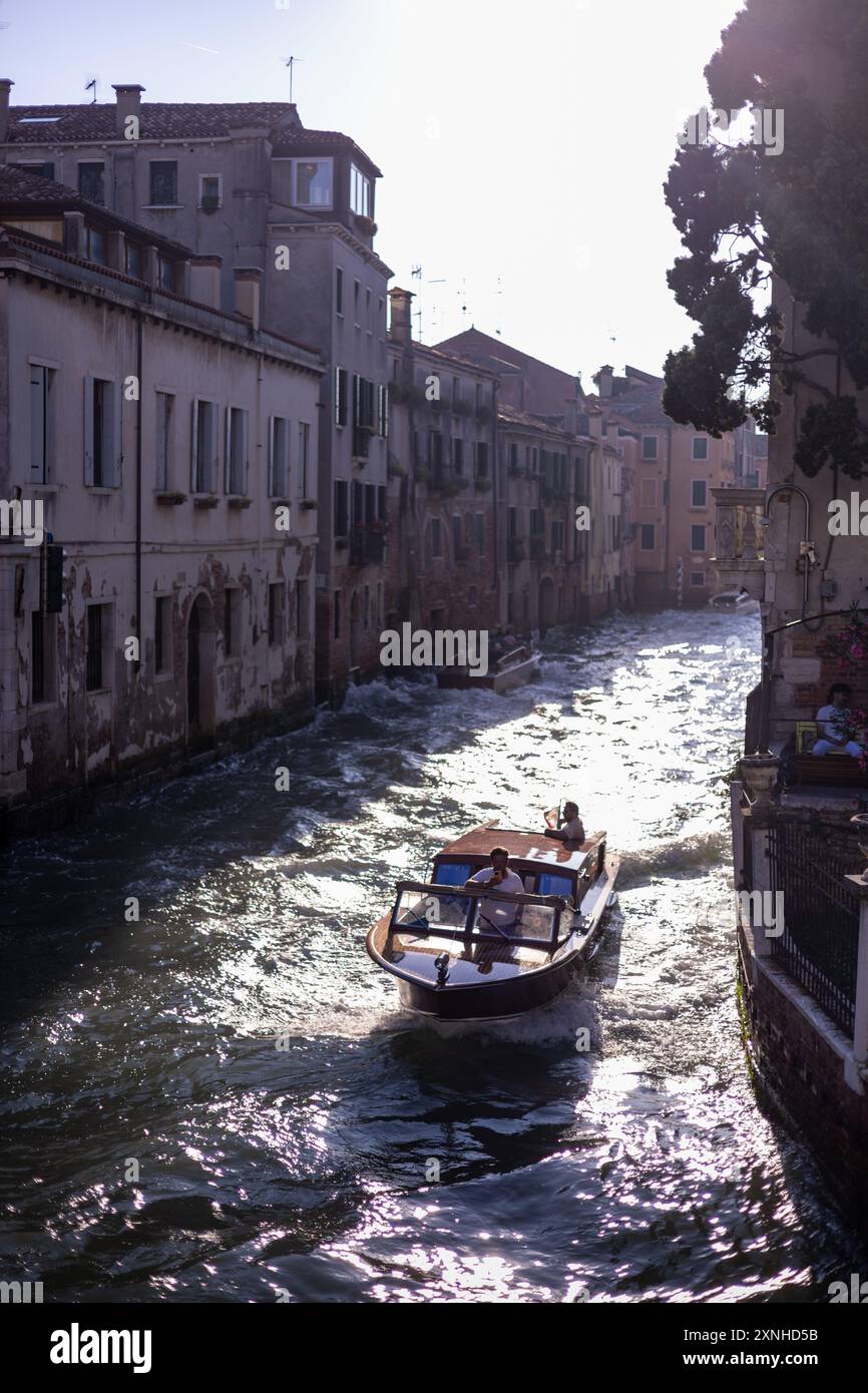 Venice canal with rough water and speedboat Stock Photo - Alamy