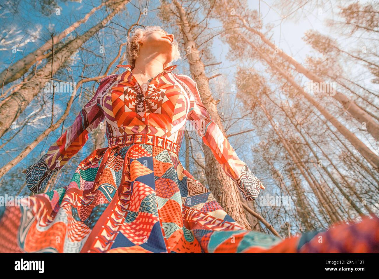 Beautiful woman in colorful ethnic dress from a low angle against the ...