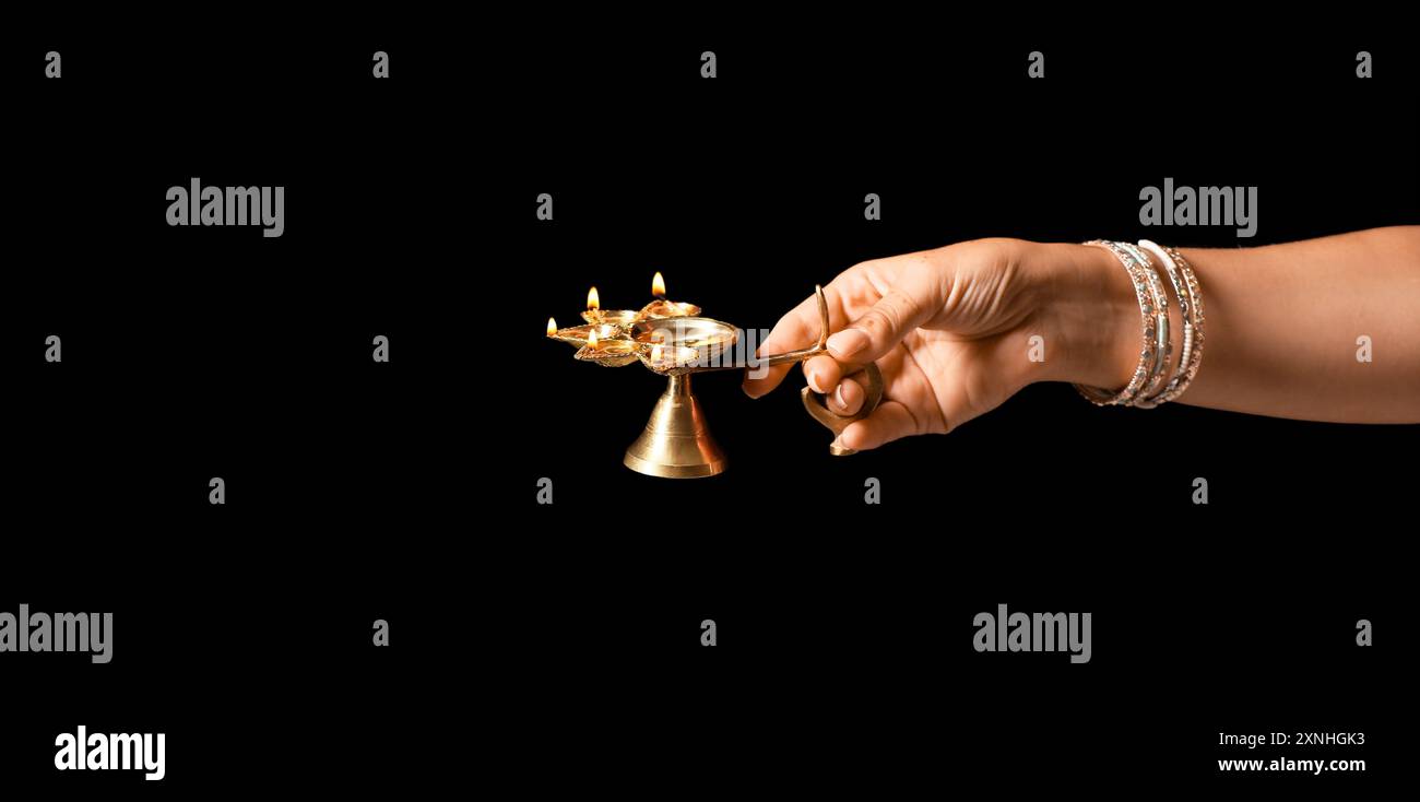 Hand holding diya hi-res stock photography and images - Alamy