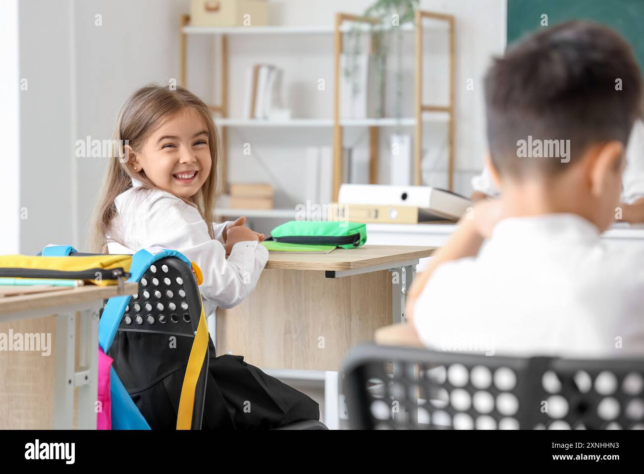 Little school girl in classroom during lesson Stock Photo - Alamy