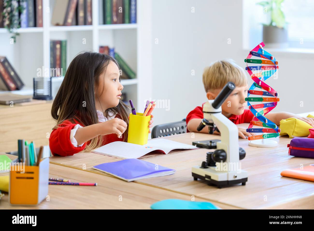 Little school children in classroom during lesson Stock Photo - Alamy