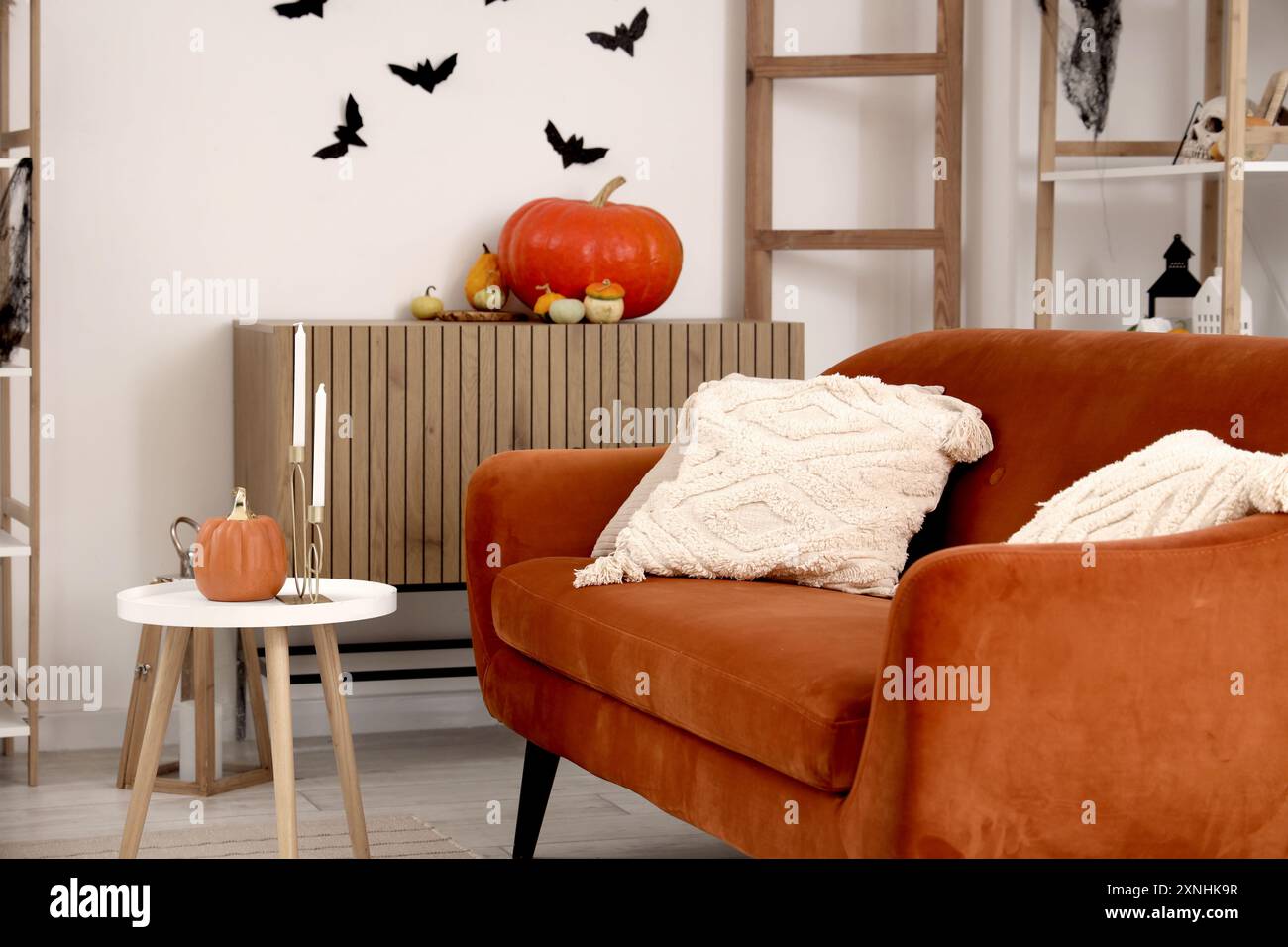 Interior of living room decorated for Halloween with red sofa and table ...