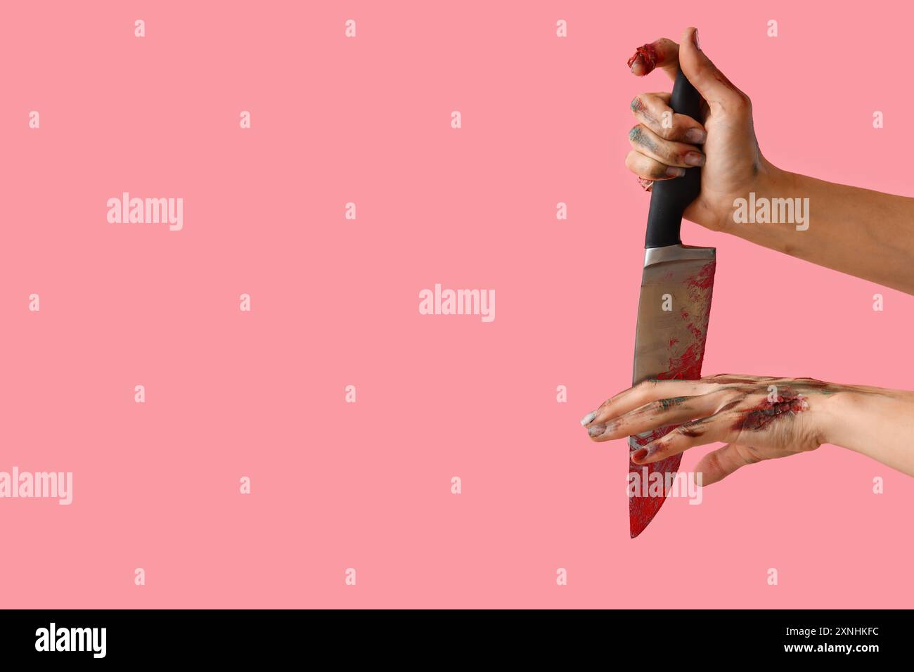 Zombie hands with bloodstained knife on pink background. Halloween ...