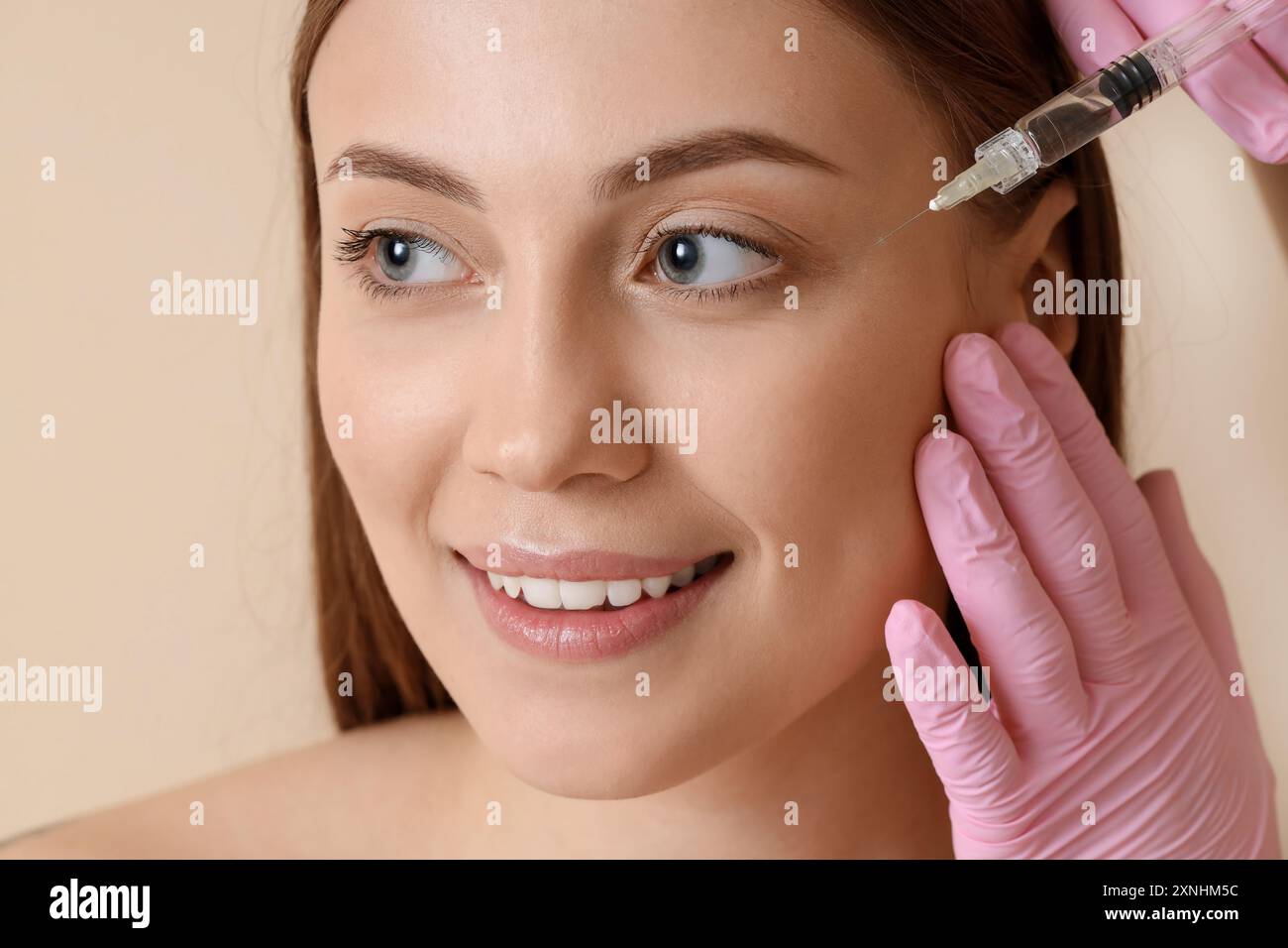 Beautiful woman receiving injection on beige background, closeup Stock ...