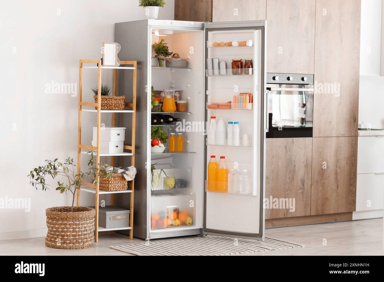 Open big fridge with fresh products in kitchen Stock Photo - Alamy