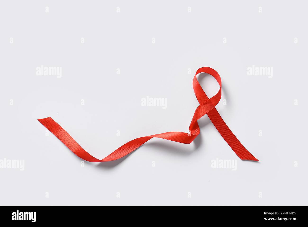Red ribbon on grey background. Blood Cancer Awareness Month Stock Photo ...