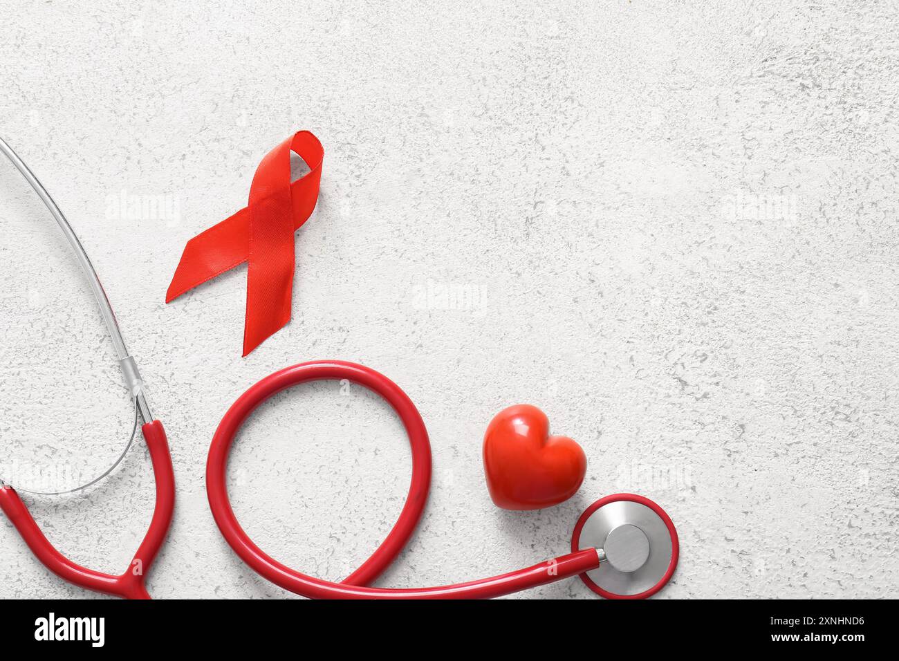 Red ribbon with stethoscope and heart on grunge white background. Blood ...
