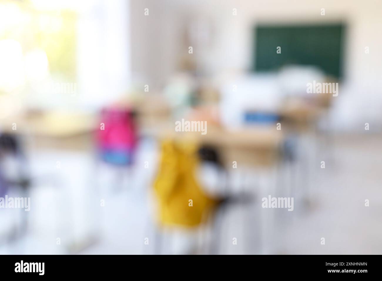 Blurred view of empty classroom with desks and blackboard Stock Photo ...