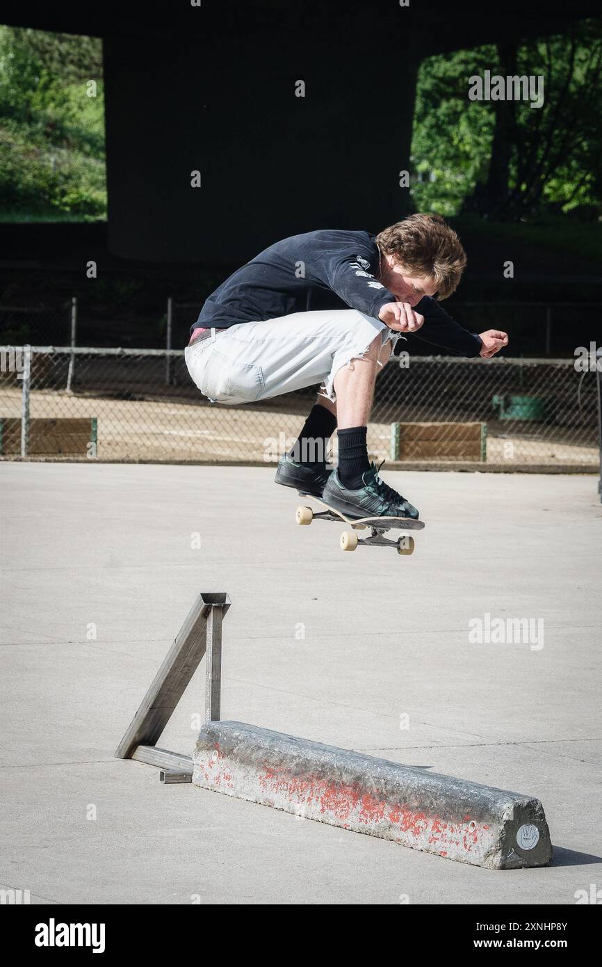 A skateboarder taking air in mid-jump at a skate park Stock Photo - Alamy