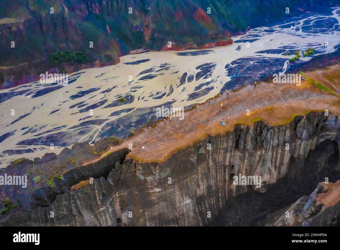 XINJIANG, CHINA - JULY 31, 2024 - Tourists brave the rain to view the ...