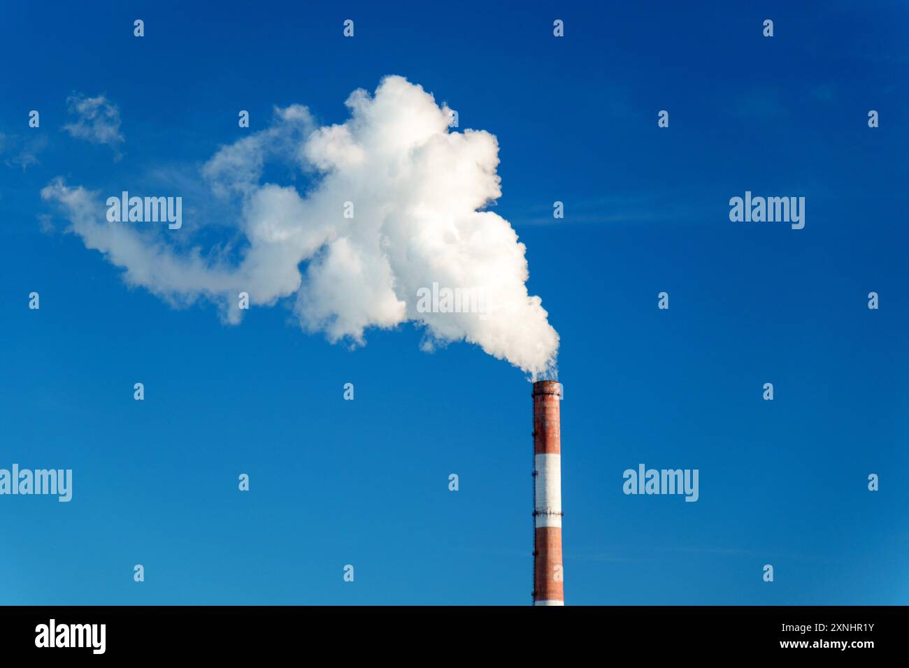 Smokestack emits thick creating a striking visual image of industrial ...