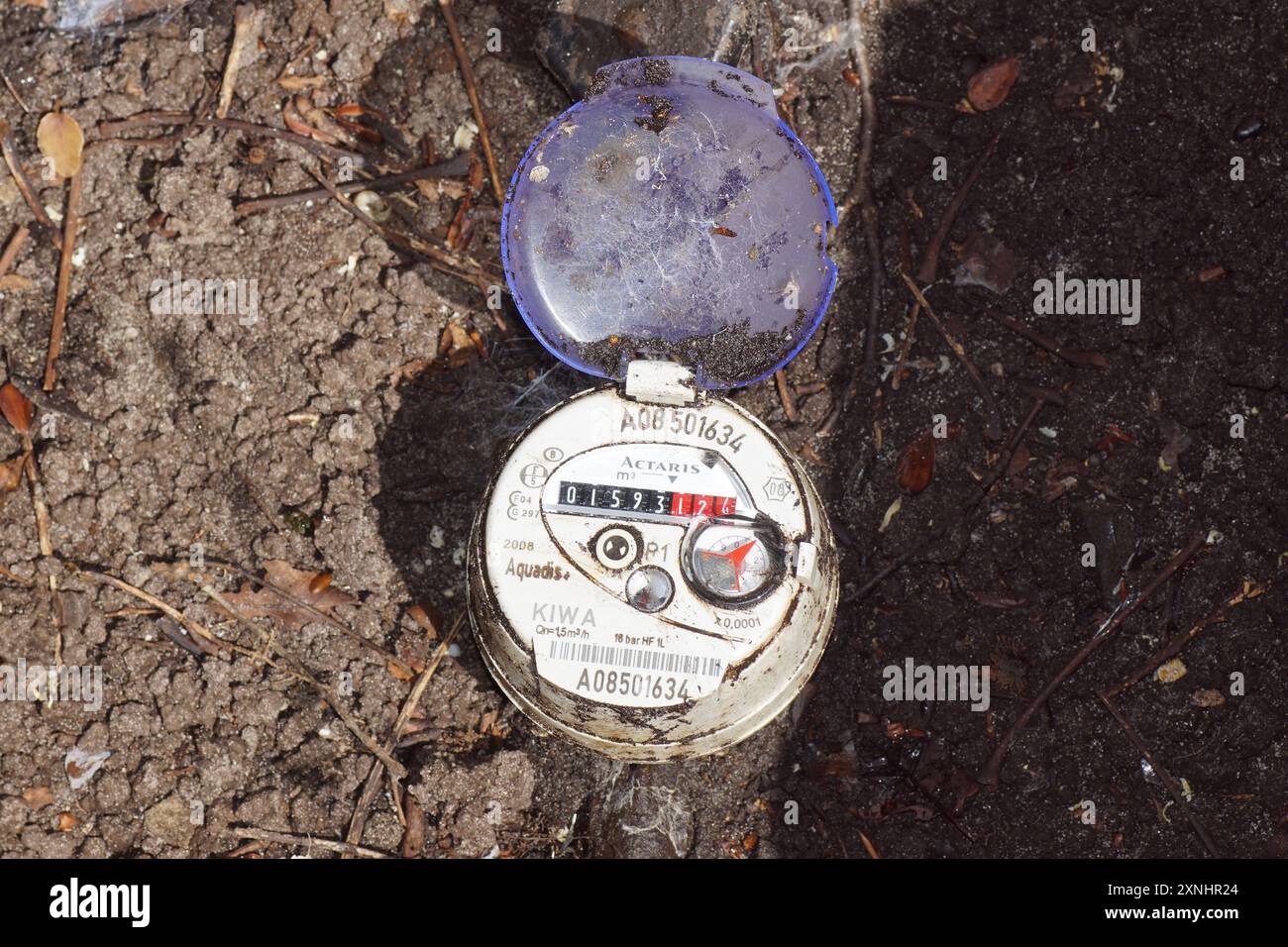 Dutch Actaris water meter in an old water meter pit. Soil. Round box ...