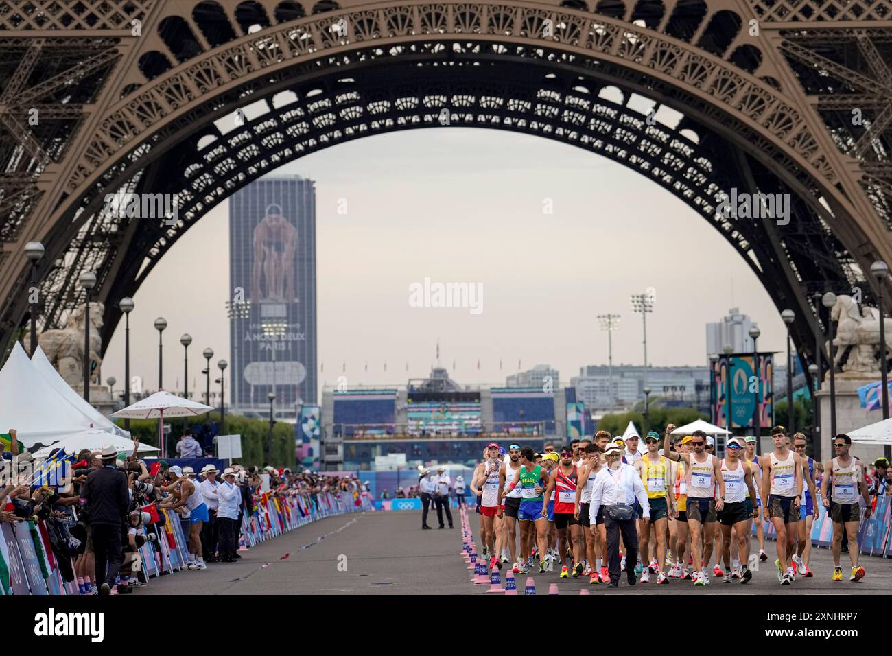 Fans cheer as athletes line up to start the men's 20km race walk at the ...