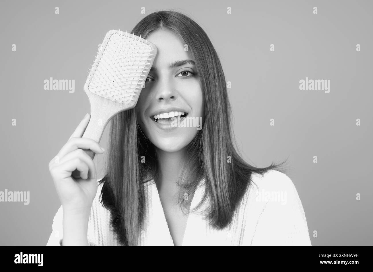 Young woman taking care with hair comb of her hair. Haircare. Pretty ...