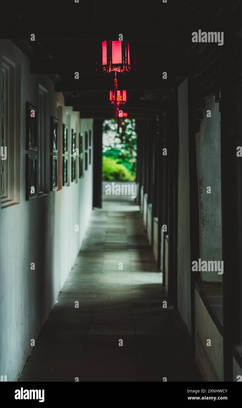 A narrow walkway in a traditional Chinese garden in Suzhou, China. The ...