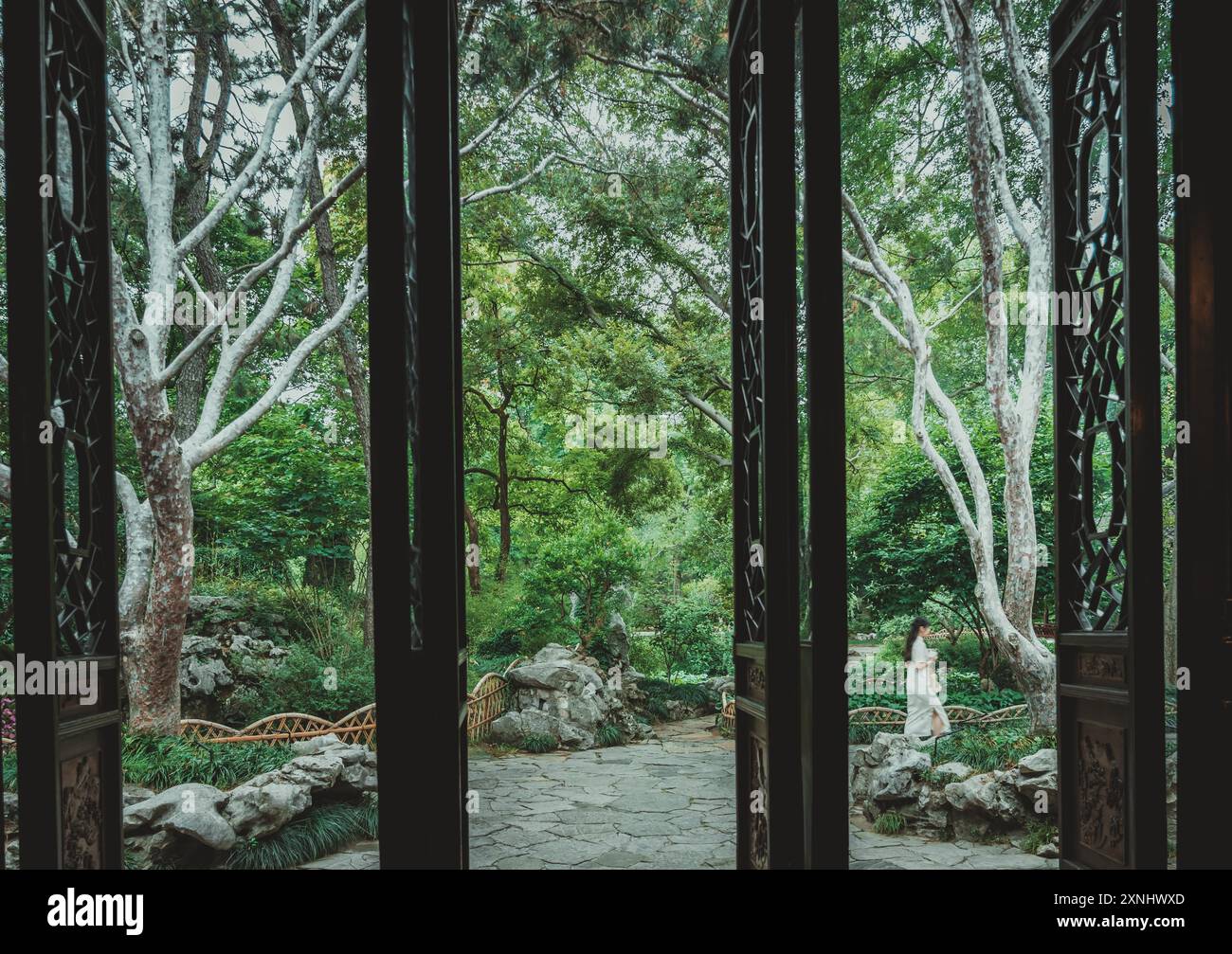 Suzhou, China - June 11, 2024 : A partially open wooden door frame ...