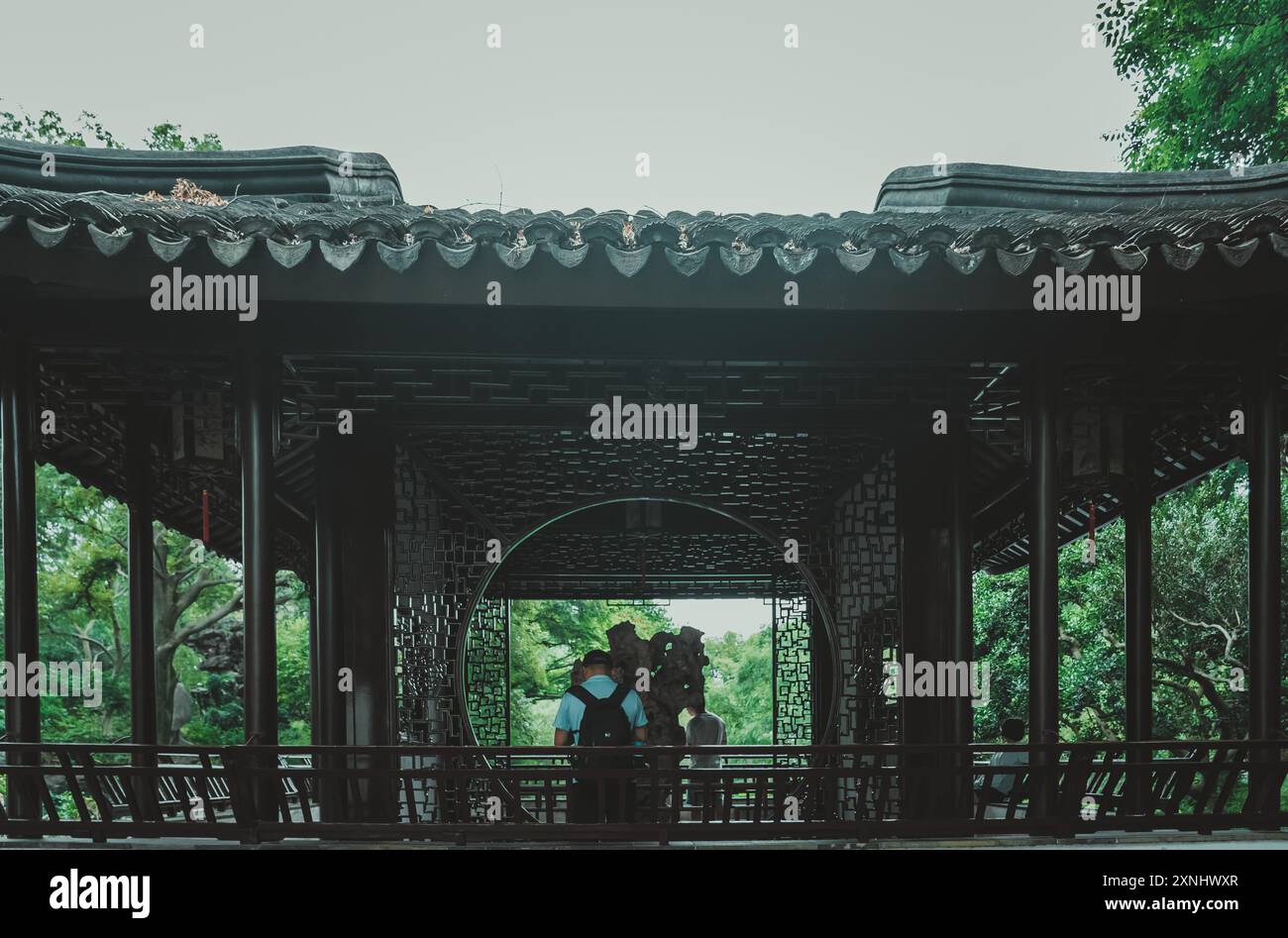 Suzhou, China - June 11, 2024 : A black wooden structure with a tiled ...