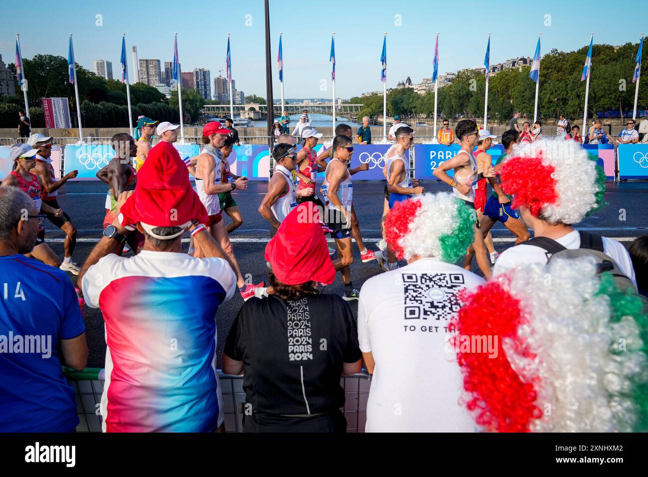 Fans cheer as athletes compete during the men's 20km race walk at the ...