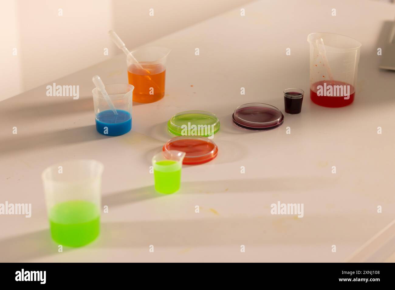 Science experiment in high school, various colorful liquids in beakers ...