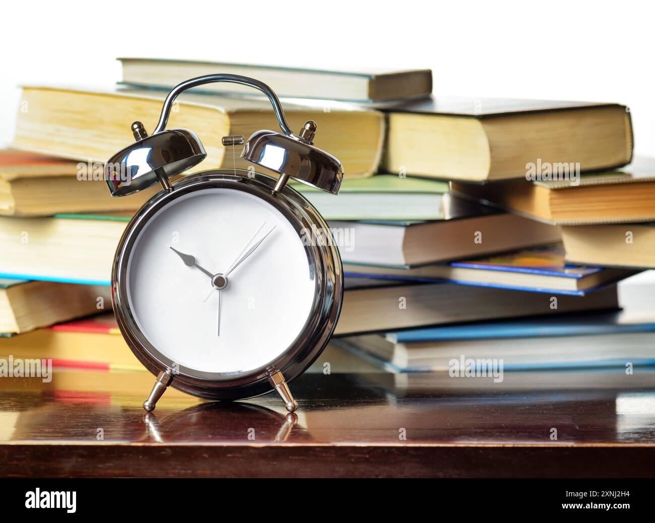 Alarm clock and books. Education concept Stock Photo - Alamy