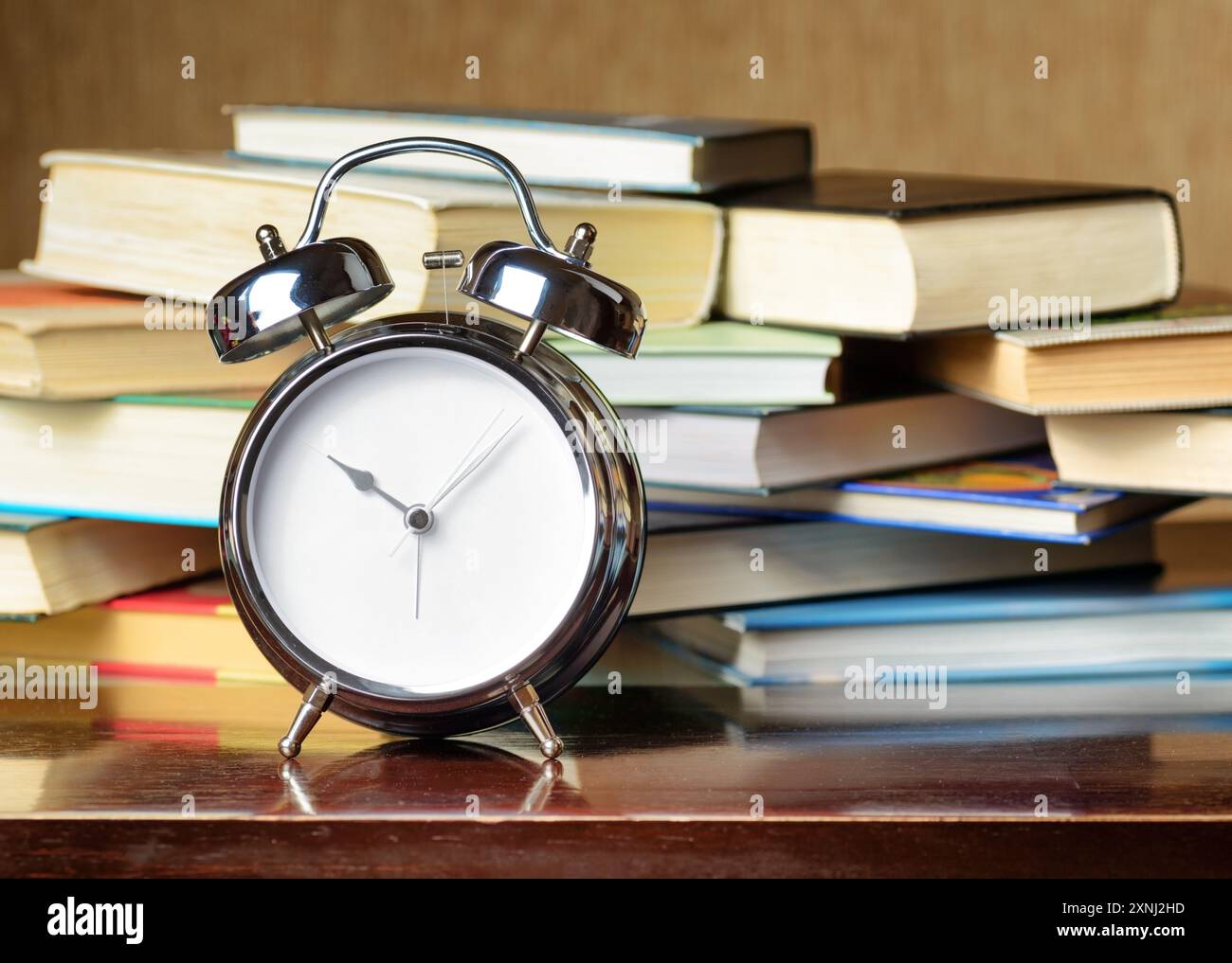 Alarm clock and books. Education concept Stock Photo - Alamy