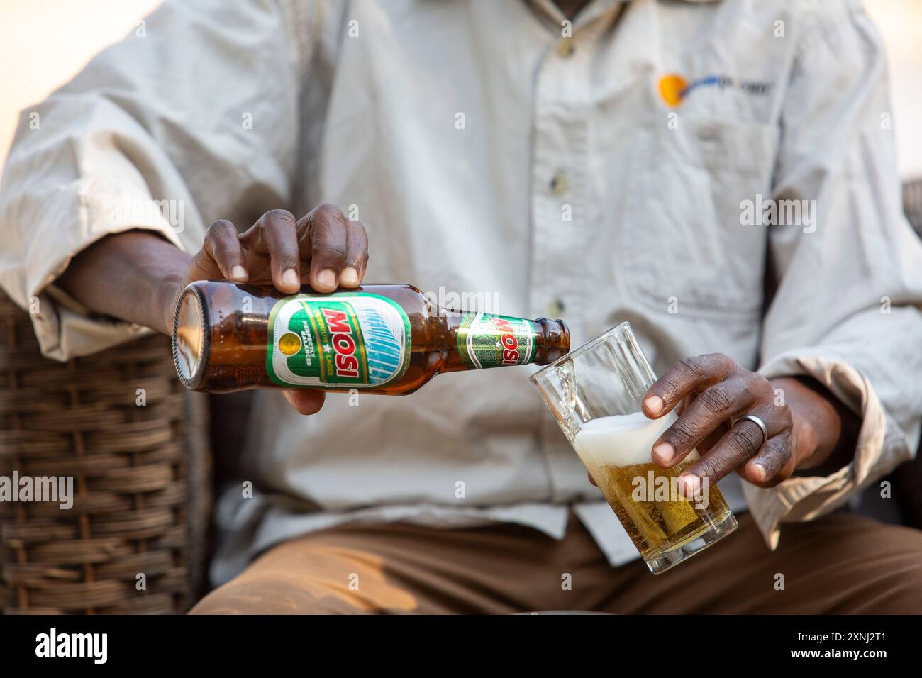 Zambian pouring local Mosi beer into a beer glass Stock Photo - Alamy