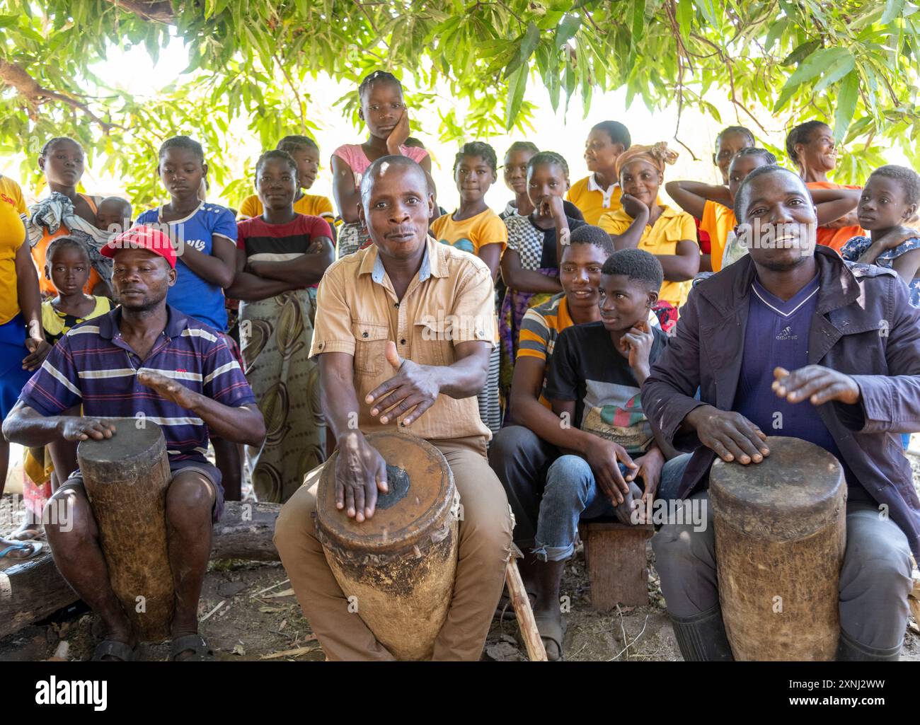 Three Senga drummers performing in a village in rural Zambia with local ...