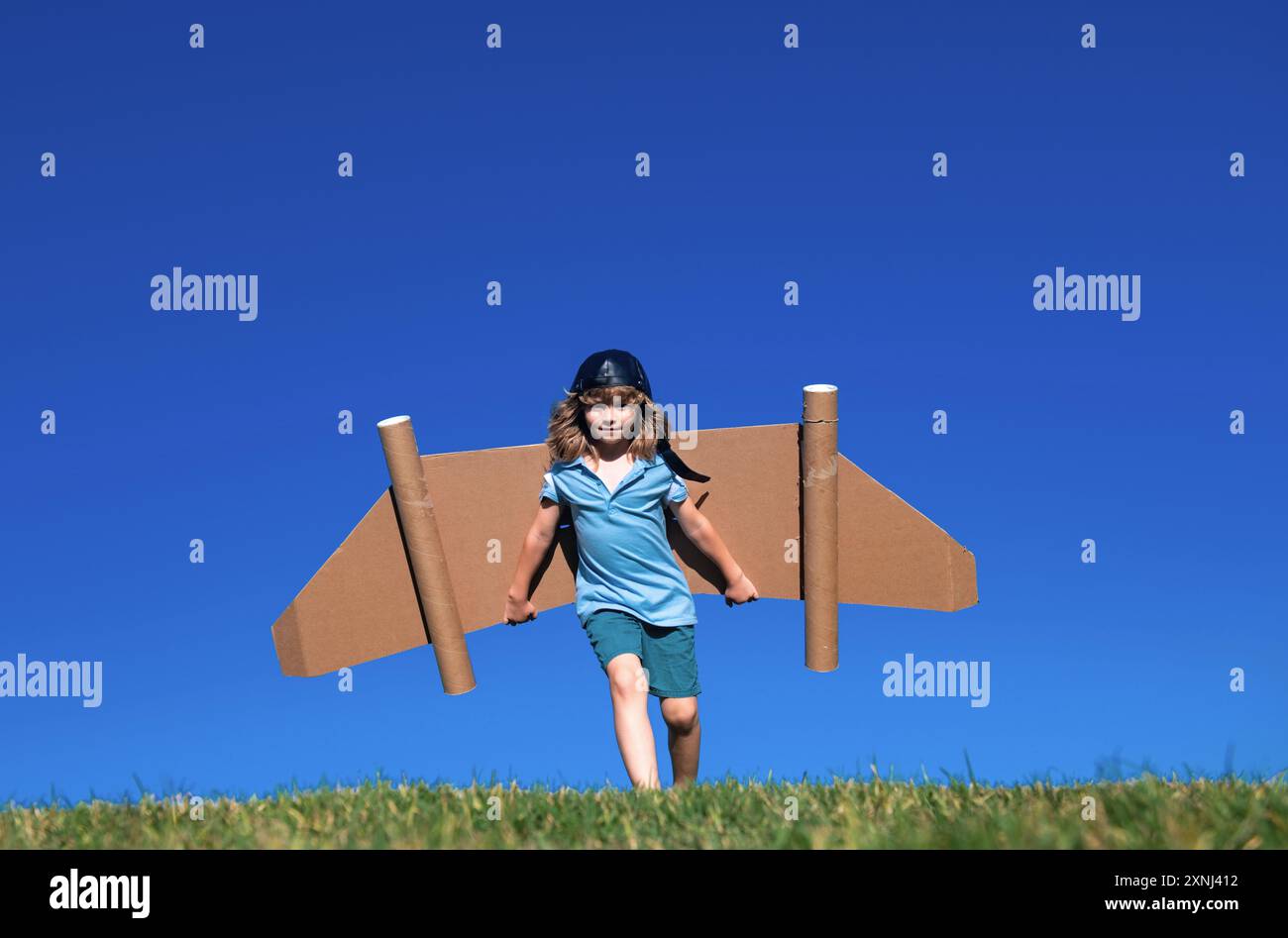 Boy child with wings at sky imagines a pilot and dreams of flying. Kids ...