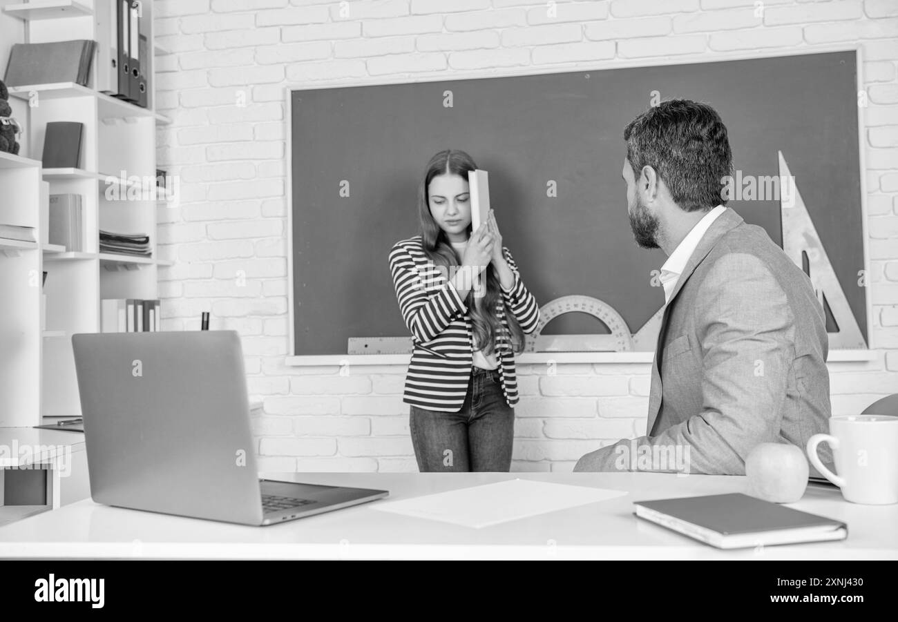 strict school teacher with selective focus of child at blackboard Stock ...