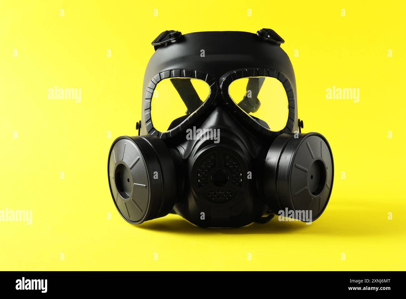 One gas mask on yellow background. Safety equipment Stock Photo - Alamy