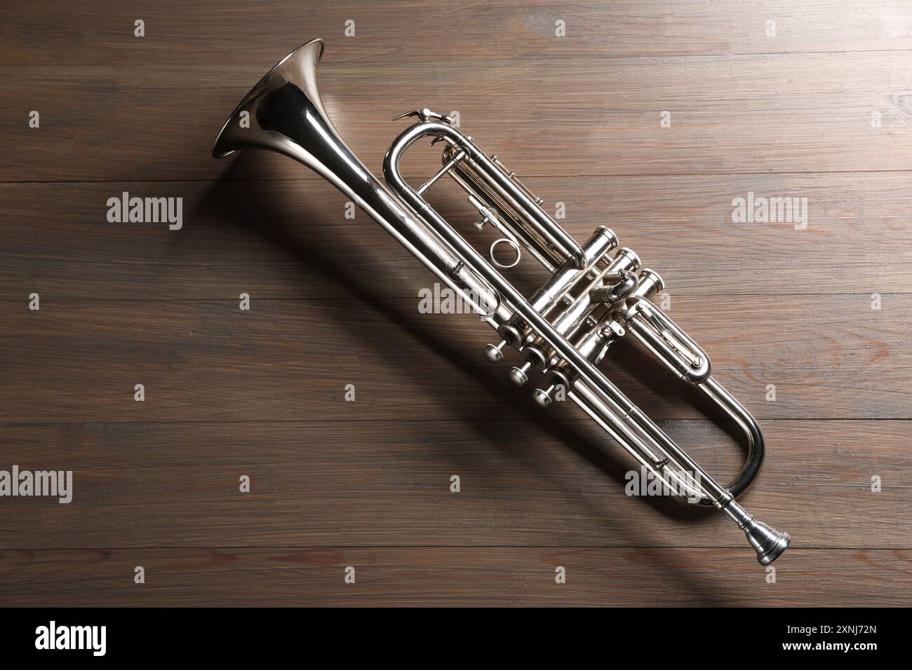 One trumpet on wooden table, top view Stock Photo - Alamy