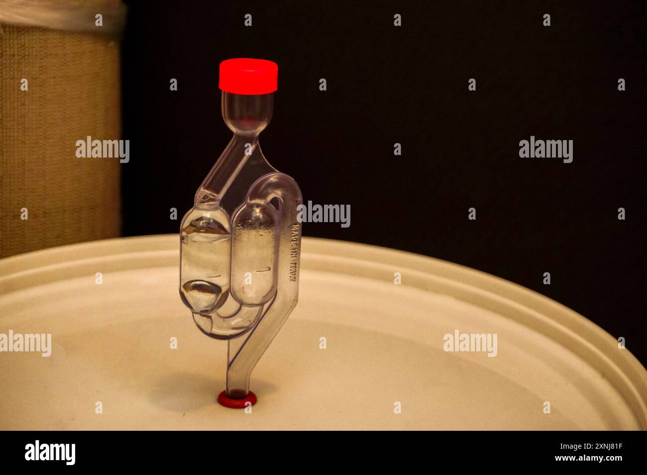 Airlock on home brewing bucket close up view Stock Photo - Alamy
