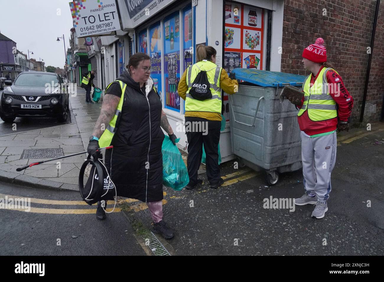 Volunteers clear debris on Murray Street in Hartlepool following a ...