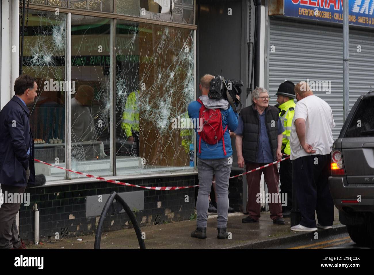 Police officers outside a damaged butchers shop on Murray Street in ...