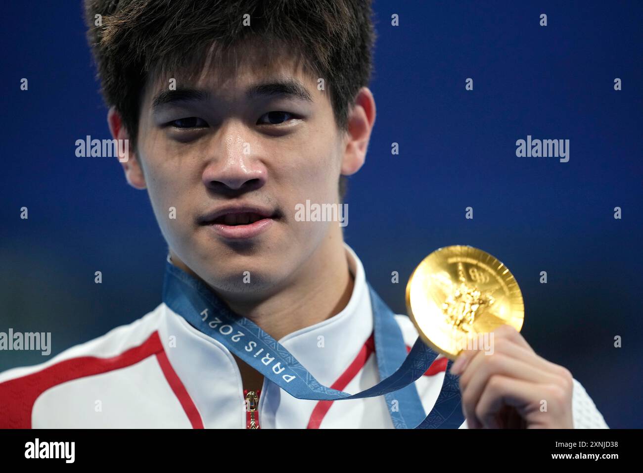 Gold medalist Pan Zhanle, of China, poses after the men's 100-meter ...