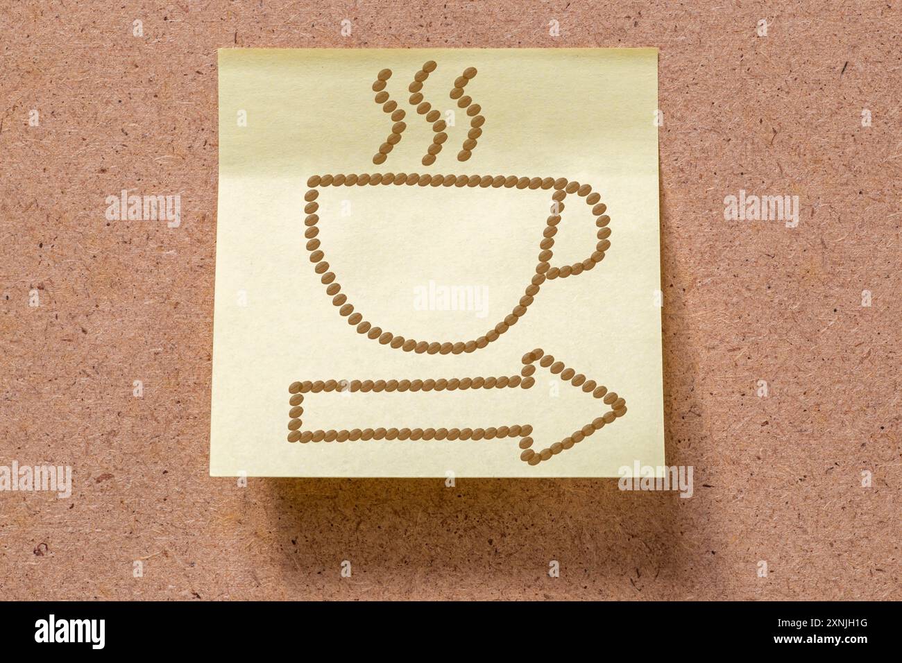 hot cup of coffee and arrow drawn with coffee beans on memory note ...